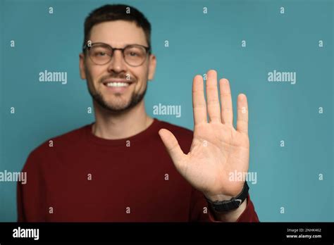 Left Handed Man Against Light Blue Background Focus On Palm Stock