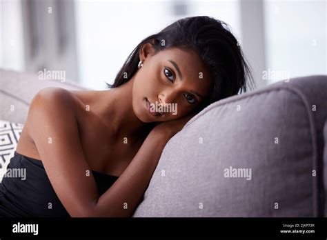 Beauty And The Couch An Attractive Young Woman Sitting Alone On The