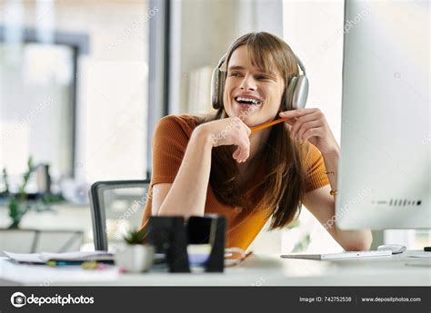 Bright Office Young Non Binary Individual Smiles While Working Wearing