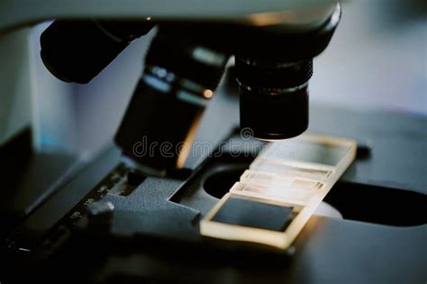 Close Up Image Showing Microscope Slide On Laboratory Microscope Stock