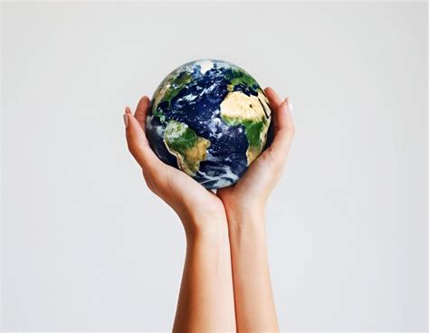 Premium Photo A Woman Holding A Globe Earth Day Concept