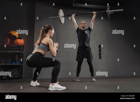 Fit Caucasian Couple Doing Crossfit Exercises At Dark Gym Attractive