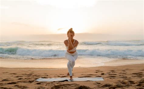 Woman Practicing Yoga Pose At Beach During Sunset Stock Image Image