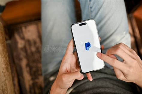 Top View Of A Man Sitting In His Room And Using Paypal Application On