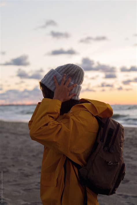 Woman Adjusting Hat At Seaside By Stocksy Contributor Danil Nevsky