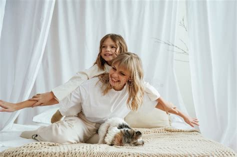 Wellness Having Fun On The Bed Mother With Daughter Are At Home