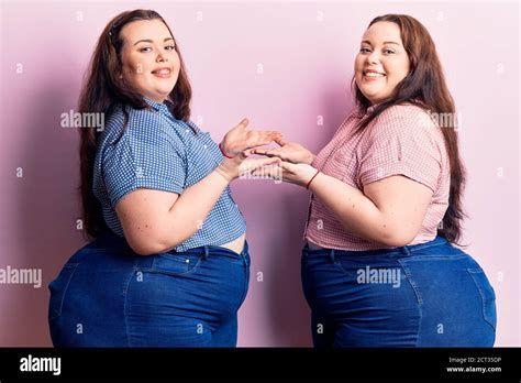Young Plus Size Twins Wearing Casual Clothes Pointing Aside With Hands Open Palms Showing Copy