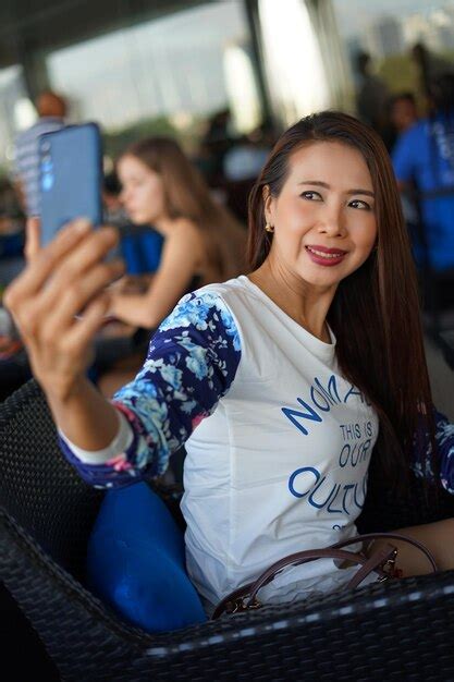 Premium Photo Smiling Woman Taking Selfie