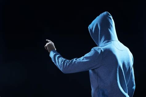 Premium Photo Hacker Pushing Button On Virtual Screen Against Dark Background