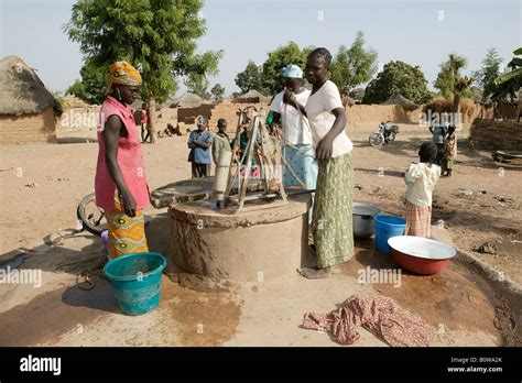 Women Fetching Water From A Well Cameroon Africa Stock Photo