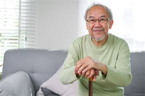 Senior Holding Walking Stick Happy Senior Portrait Indoor Looking
