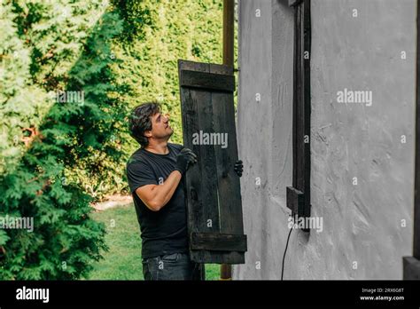 Man Installing Window Of Old House Stock Photo Alamy