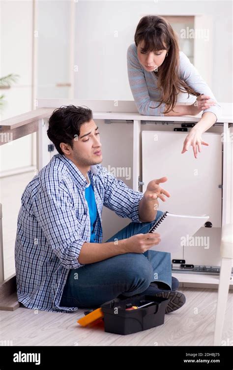 Husband Repairing Broken Table At Home Stock Photo Alamy