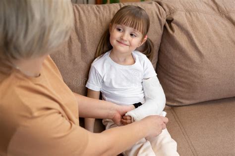 Mom Wraps A Bandage Around Her Daughter S Broken Arm Gypsum Stock