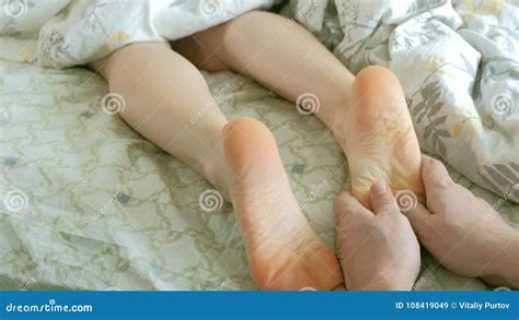 Male Hands Are Doing A Foot Massage Woman Lying In Bed Stock Video