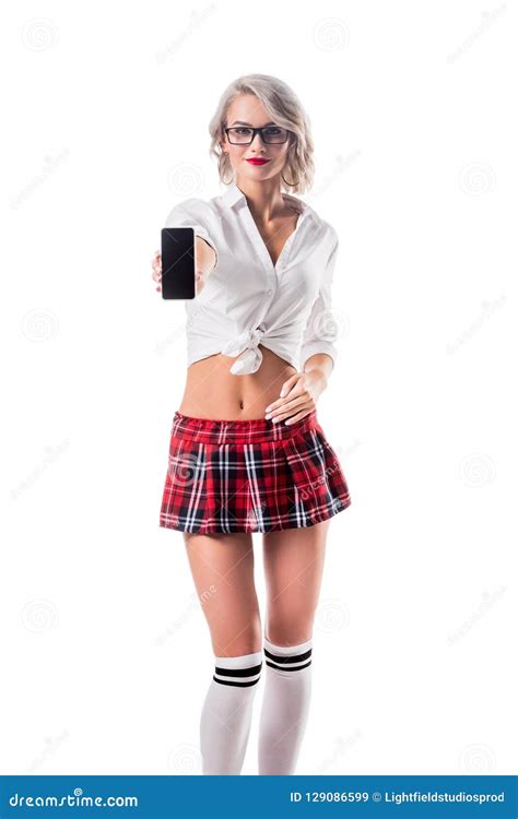Young Woman In Seductive Schoolgirl Clothing Showing Smartphone With Blank Screen Stock Image