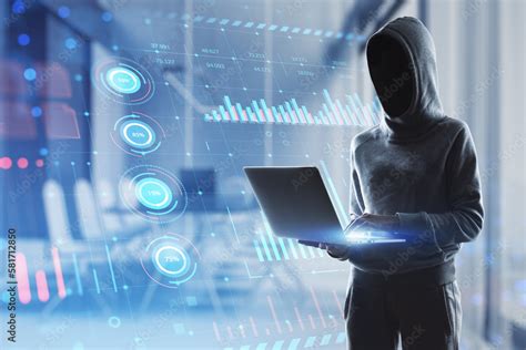 hacker using laptop with glowing digital interface with business charts