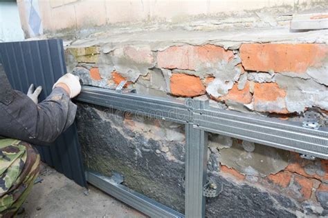 Builder`s Hands Fixing Steel Reinforcement Bars At Construction Site