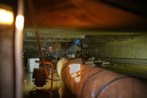 Construction Worker Wearing Safety Harness Working In Confined Space
