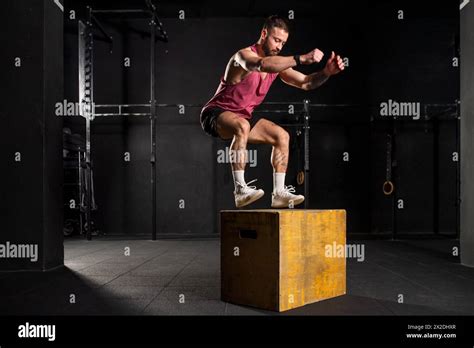 Man In Sportwear Jumping Onto Yellow Box Vertical Box Jumps Workout Routine Workout For
