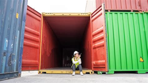 Premium Photo Woman Foreman Smile Sit Down Inside Of Cargo Container In Warehouse Manager