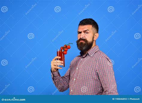 Man With Beard Holds Tomato Juice On Blue Background Stock Image Image Of Fresh Cherry