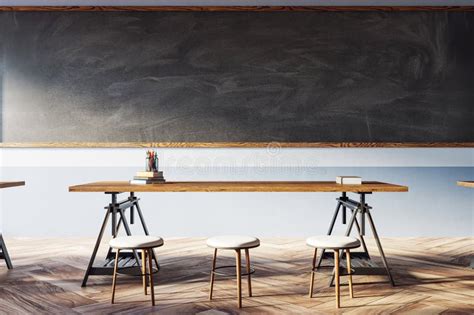 Modern Classroom Interior With Empty Wooden Desks And A Large Blackboard 3d Rendering Stock