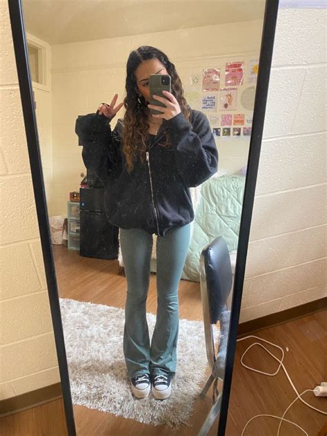 Girl Posing In The Mirror In Green Flare Leggings And An Oversized