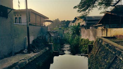 A Narrow Concrete Lined Canal Flowing Through A Residential Stock