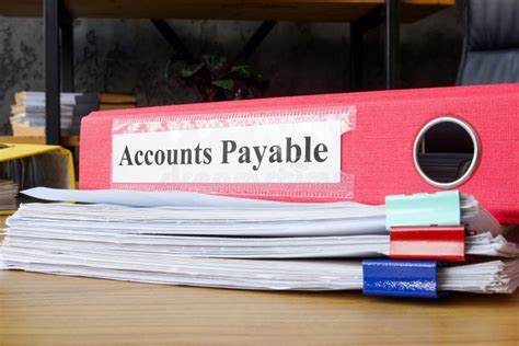 Stack Of Papers And Folder Labeled Accounts Payable Financial