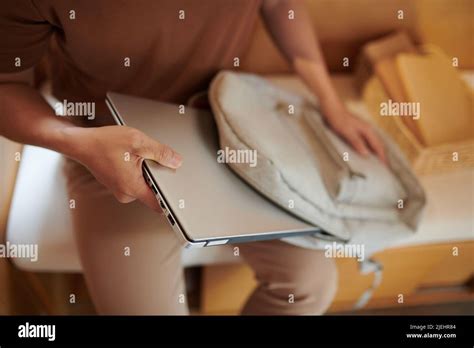 College Student Putting Laptop In Backpack When Getting Ready In The
