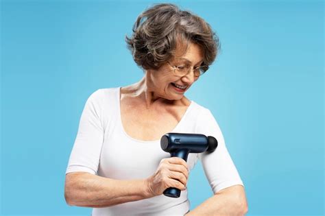 Premium Photo Smiling Senior Woman Modern Grandmother Using Massage
