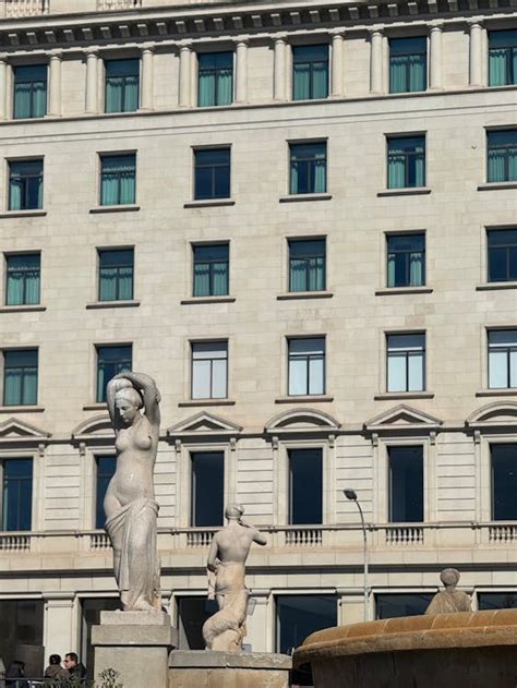 Classical Statues In Urban Setting With Historic Architecture · Free
