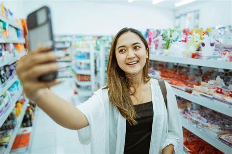 Young Asian Woman Takes A Selfie While Shopping At A Minimarket Stock Image Image Of Item