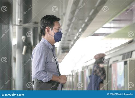 Man Commuter With Face Mask On Standing On The Subway Platform Waiting