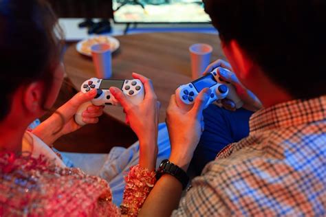 Premium Photo Cropped Hands Couple Playing Game With Joysticks At Back Side Infobahn