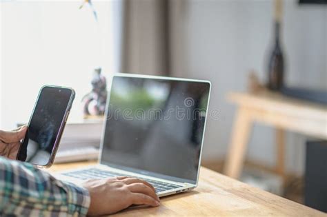 Man Hands Holding Smartphone With Laptop Keyboard Young Man Freelance Hands Typing On Laptop
