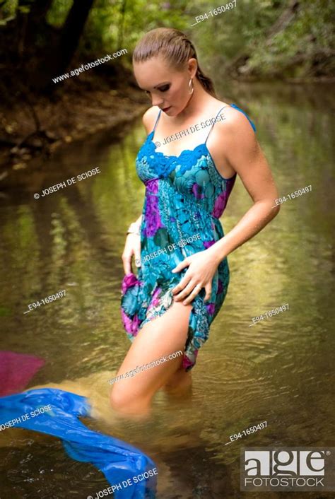 34 Year Old Blond Woman In A Short Flower Print Dress Standing In A