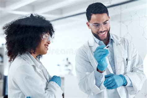 Two Young Science Experts Conducting A Research Experiment In The Lab