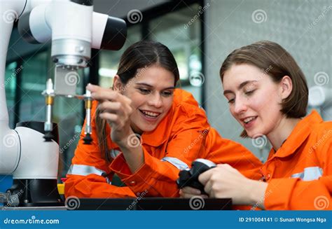 In An Electronic Parts Facility Two Female Engineers In The Plant Inspecting And Testing
