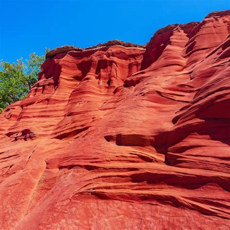 Premium Ai Image Vibrant Red Sandstone Cliffs Carved By The Forces Of