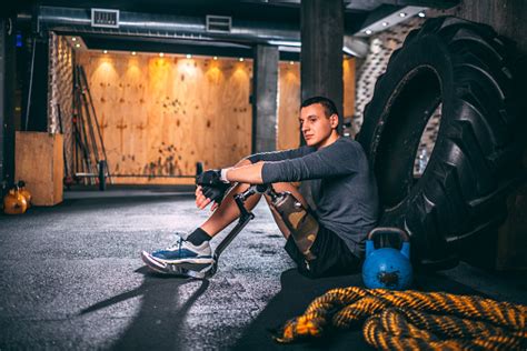 보 철 다리는 Crossfit 체육관에서 운동 후 휴식 하는 동안 숙고와 젊은 적응형 선수 건강관리와 의술에 대한 스톡 사진 및