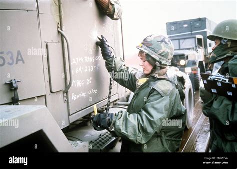 U S Army Personnel Use A Laser Scanner To Read The Bar Code On The Door Of An Army Vehicle As