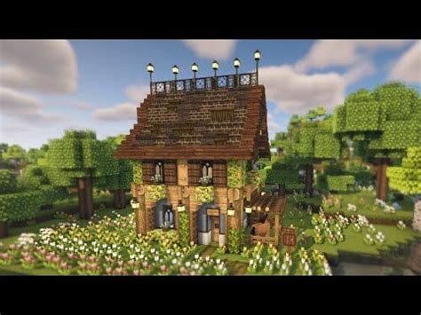 An Image Of A House In The Middle Of A Field With Flowers And Trees Around It