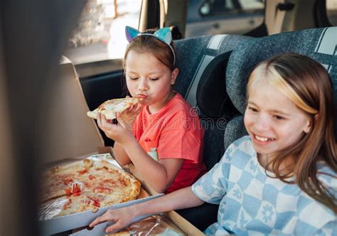 Two Positive Smiling Sisters Are Happy To Eat Just Cooked Italian Pizza