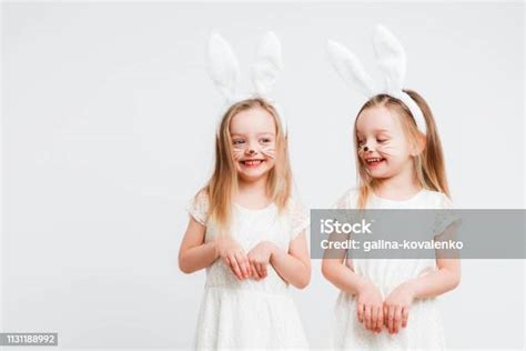 토끼 귀 흰색 드레스에 작은 금발 쌍둥이 회색 배경에 스튜디오 사진 아 이들은 부활절을 축 하 합니다 2 3 살에 대한 스톡