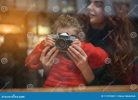 Carefree Daughter And Mother Photographing Through Window Stock Image