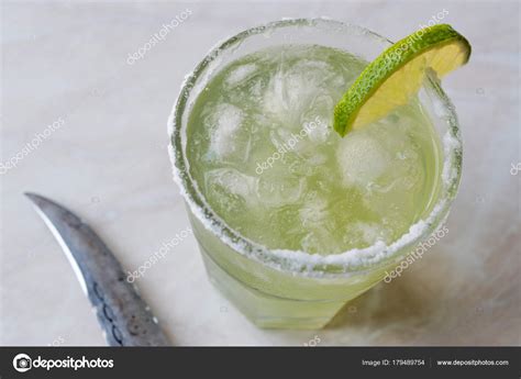 Classic Margarita Cocktail In Salted Glass With Lime And Crushed Ice