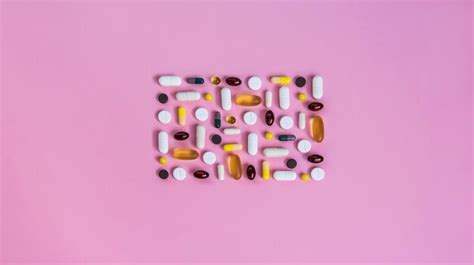 Premium Photo Different Types Of Pills Lie On A Pink Background