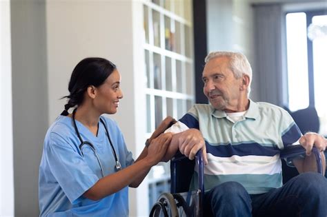 Premium Photo Smiling Biracial Female Physiotherapist Talking With